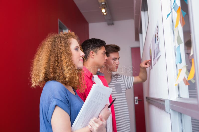 Serious Students Studying with Graphics on the Wall Stock Image - Image ...