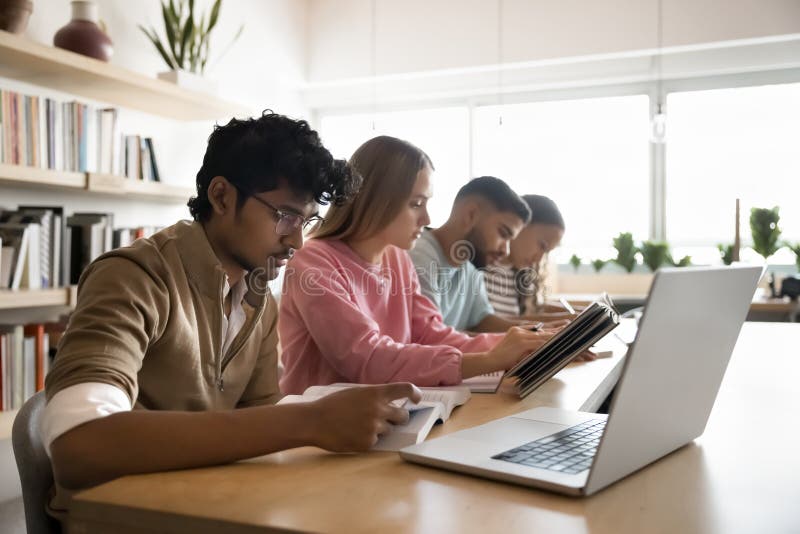 Serious Students Studying Seated at Table in Library or Classroom Stock ...