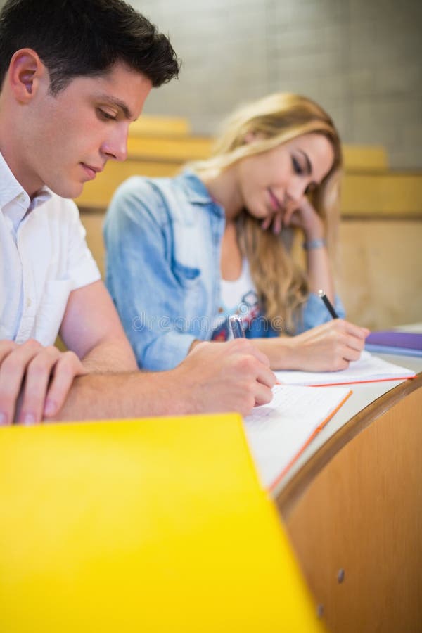 Serious Students Writing during Class Stock Photo - Image of literature ...