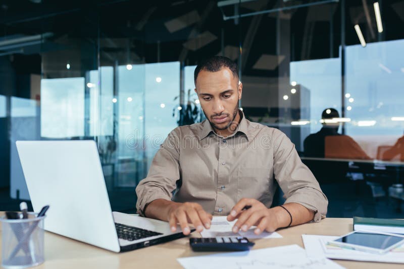 Serious Thinking Hispanic Businessman Working with Documents and ...
