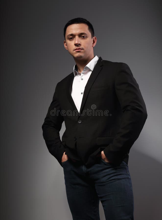 Serious Thinking Man Looking in Black Suit on Grey Studio Background ...
