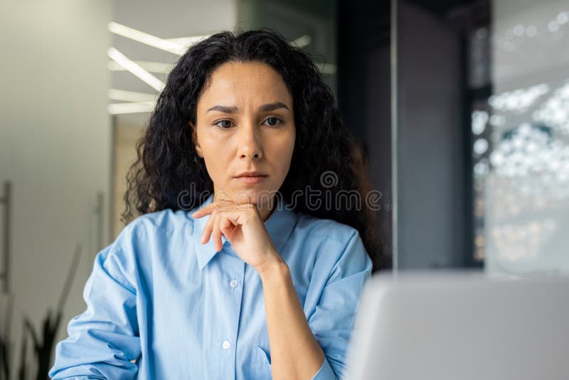 Serious Thinking Woman Working Inside Office at Workplace with Laptop ...