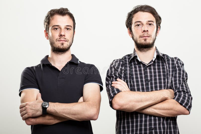 Serious Twins stock image. Image of brown, shirt, arms - 26431333