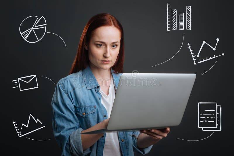 Confident Programmer Standing with a Laptop and Looking at the Screen ...