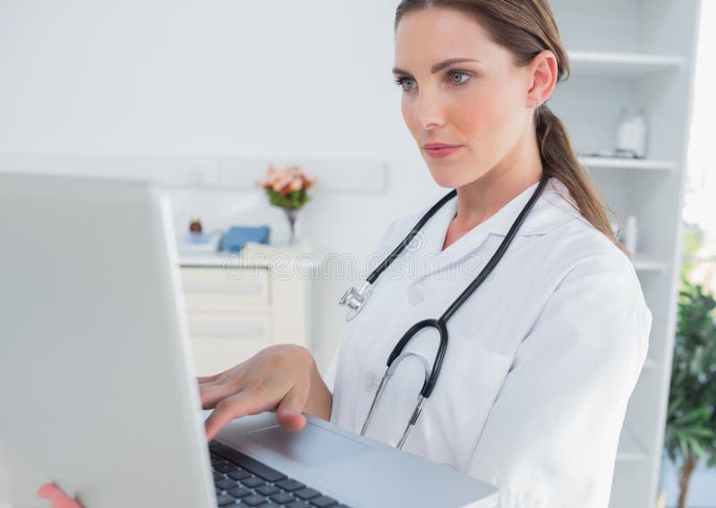 Serious Woman Doctor Using a Laptop Stock Image - Image of typing ...