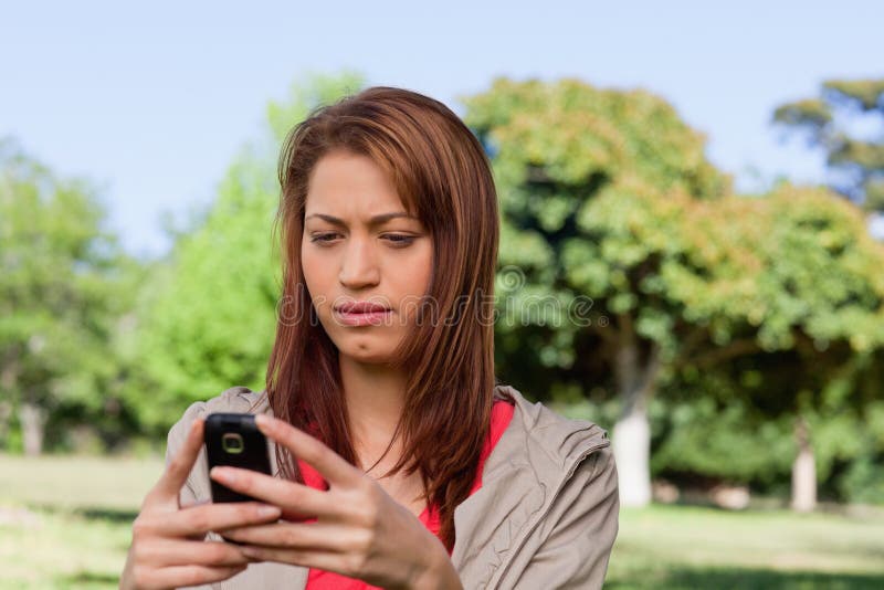 Serious Woman Reading a Text Message Stock Image - Image of hair, sunny ...