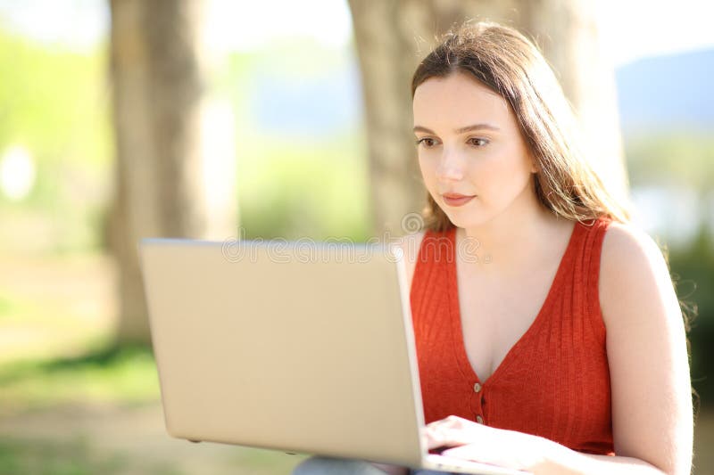 Serious Woman in Red Using Laptop in a Park Stock Image - Image of ...