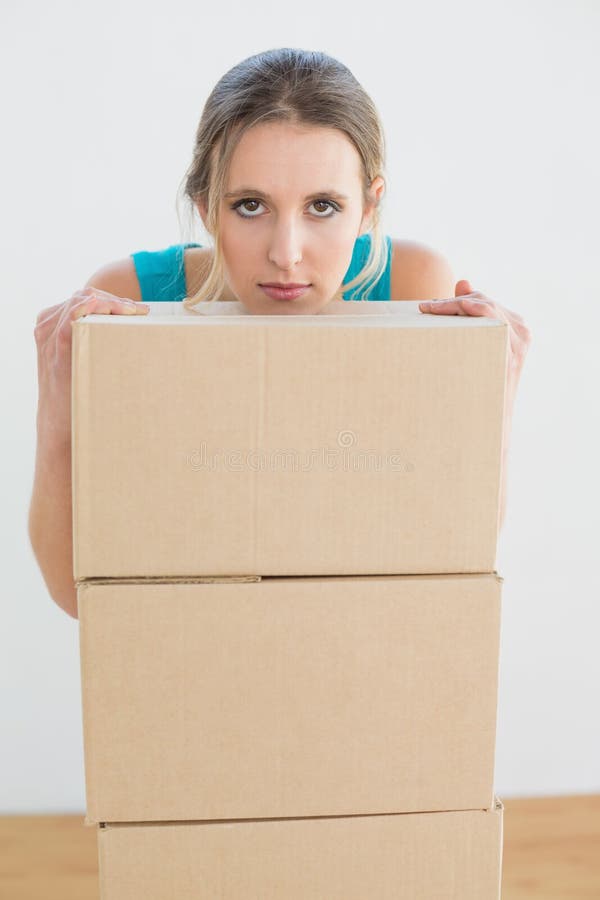 Serious Woman with a Stack of Boxes in New House Stock Photo - Image of ...