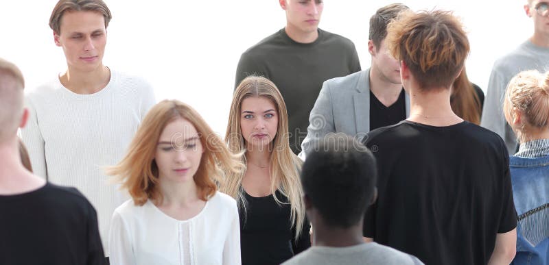 Serious Woman Standing in Front of Casual Group of Young People Stock ...