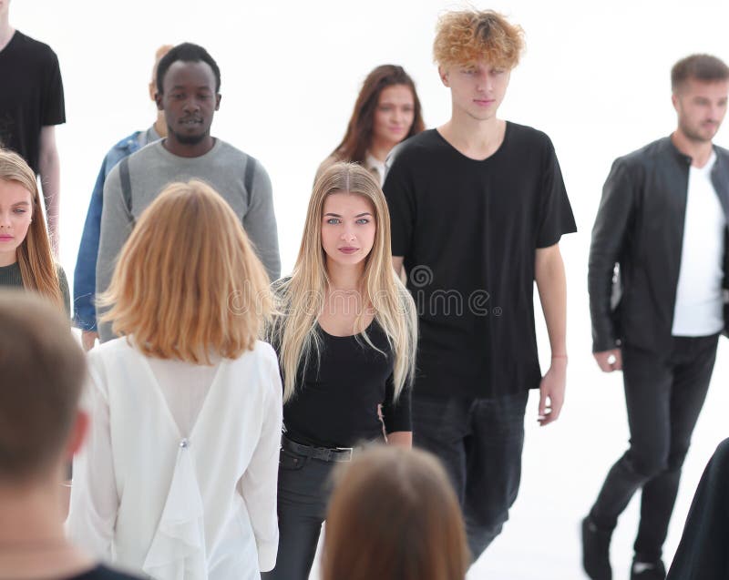 Serious Woman Standing in Front of Casual Group of Young People Stock ...