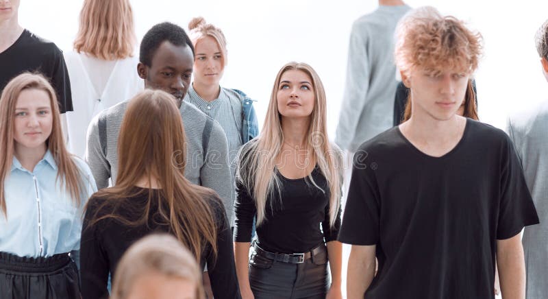 Serious Woman Standing in Front of Casual Group of Young People Stock ...