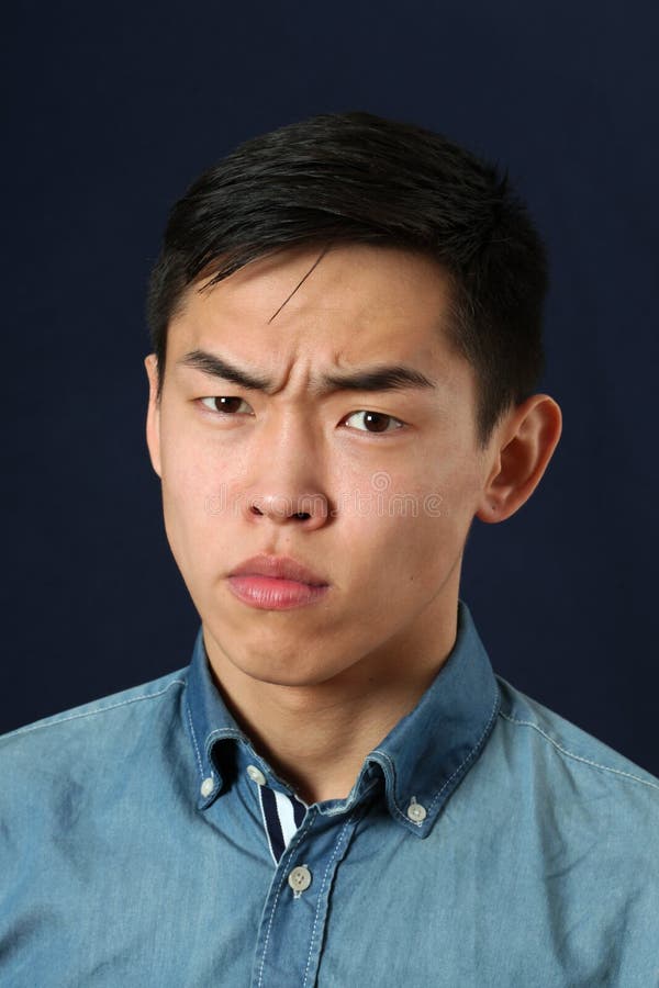 Serious young Asian man stock photo. Image of dark, displeasure - 52104032