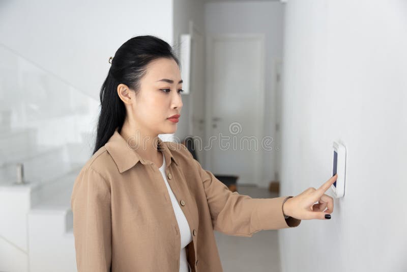 Serious Young Asian Woman Activating Air Conditioning Panel Stock Image ...