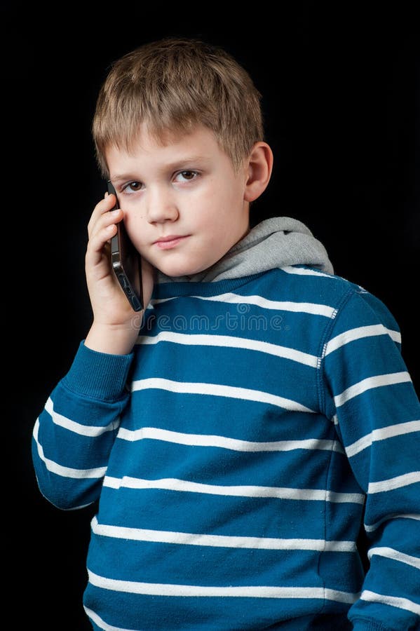 Serious Young Boy Talking on Mobile Phone Stock Image - Image of hands ...