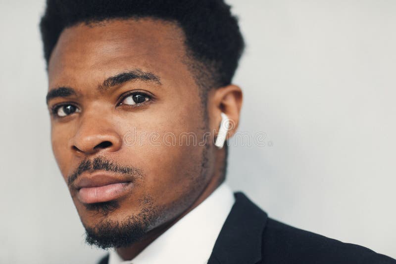 Serious Young Businessman Using Bluetooth Earbuds Stock Photo - Image ...