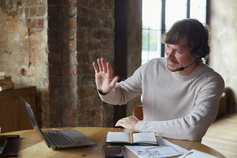 Serious Young Caucasian Man Speaking by Video Call and Looking at ...