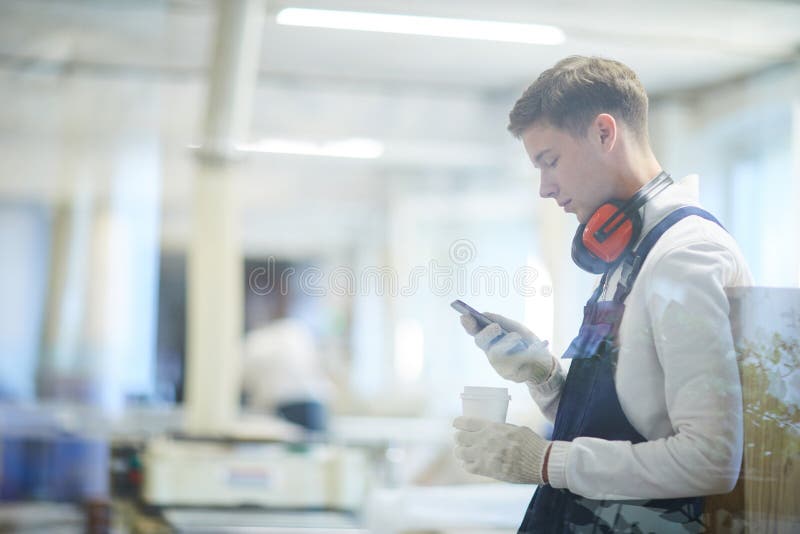 Serious Young Construction Worker Using Gadget at Break Stock Image ...