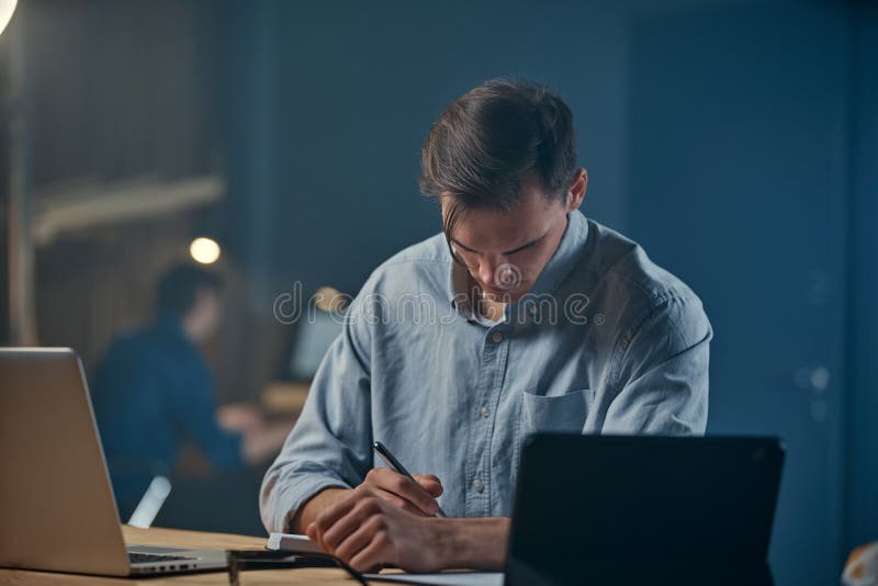Serious Young Entrepreneur Writing Something Down in His Weekly . Stock ...