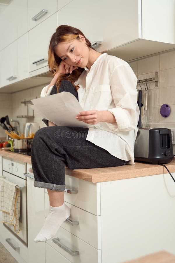 Serious Young Female Concentrated on Reading Documentation Stock Photo - Image of dwelling ...