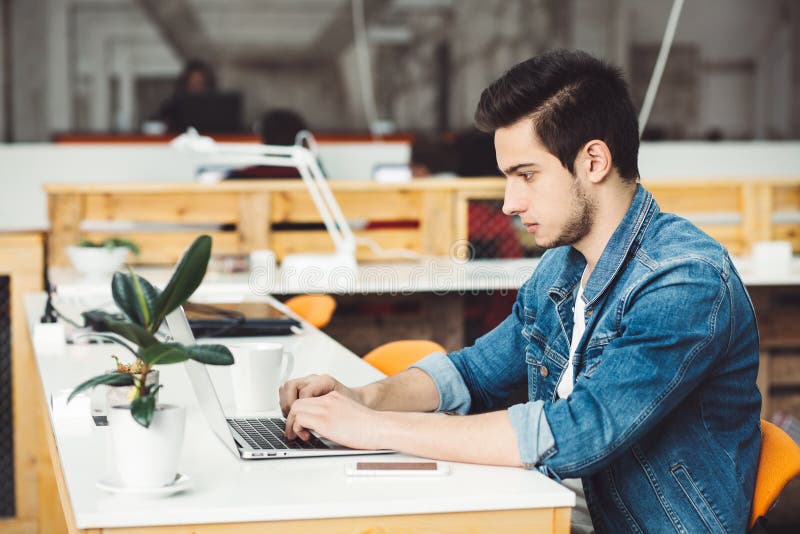 Serious Young Guy with Beard Working on Laptop Stock Photo - Image of ...