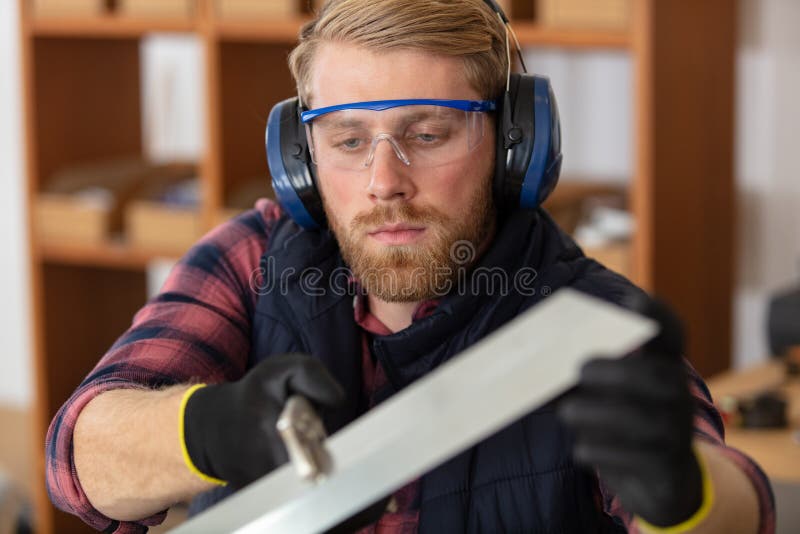 Serious Young Male Carpenter Working with Wood Stock Image - Image of ...