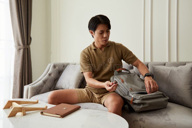 Man Packing Backpack stock photo. Image of student, opening - 260363000