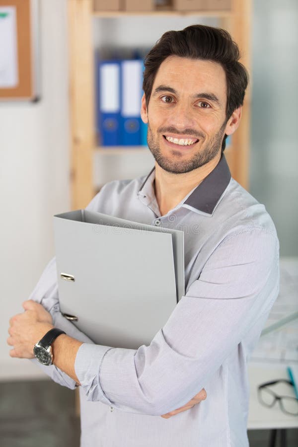 Serious Young Man Standing with Binder Stock Image - Image of portrait ...