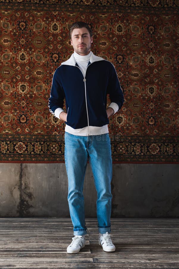 Serious Young Man in Stylish Clothes in Front of Rug Hanging Stock ...