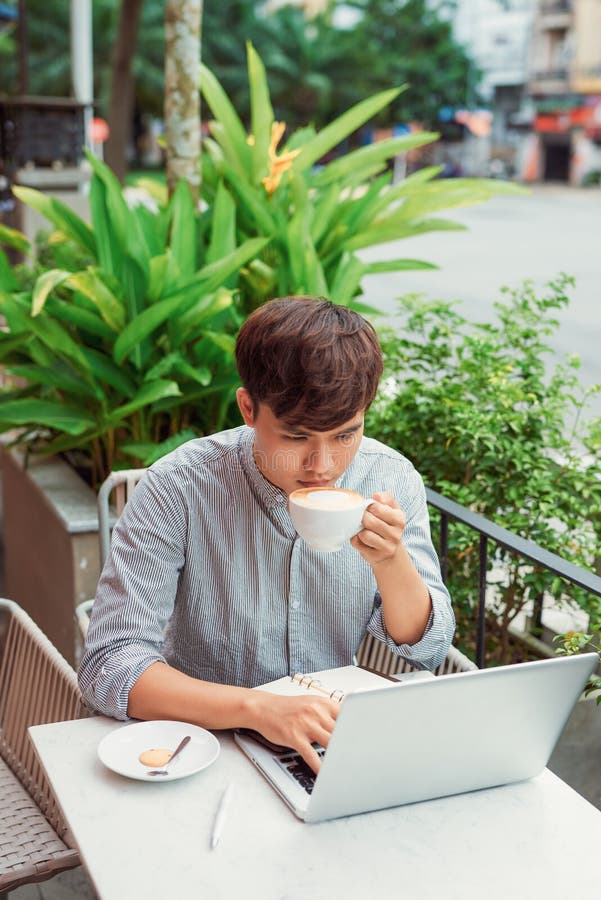 Serious Young Man Using a Laptop for Work Outdoor Stock Image - Image ...