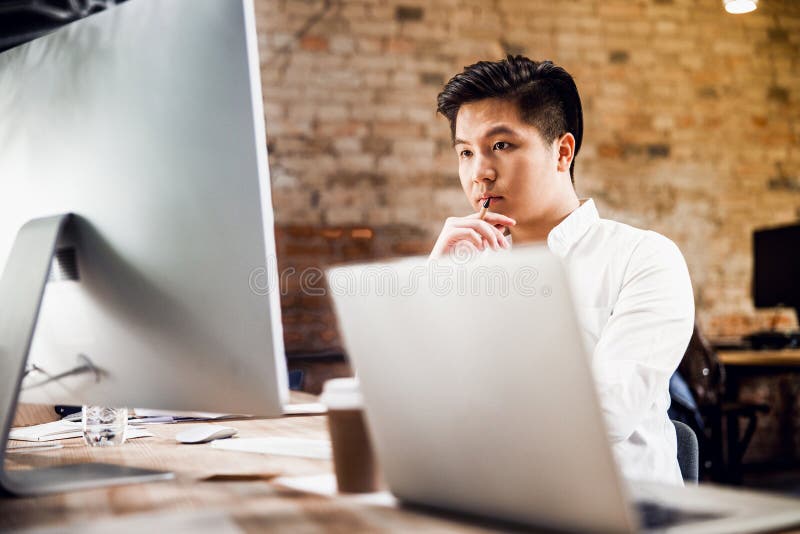 Serious Young Man Using Modern Computer at Work Stock Photo - Image of ...