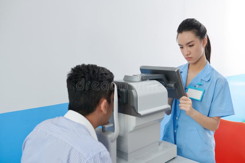 Examining Eyes with Refractometer Stock Photo - Image of opthalmologist ...