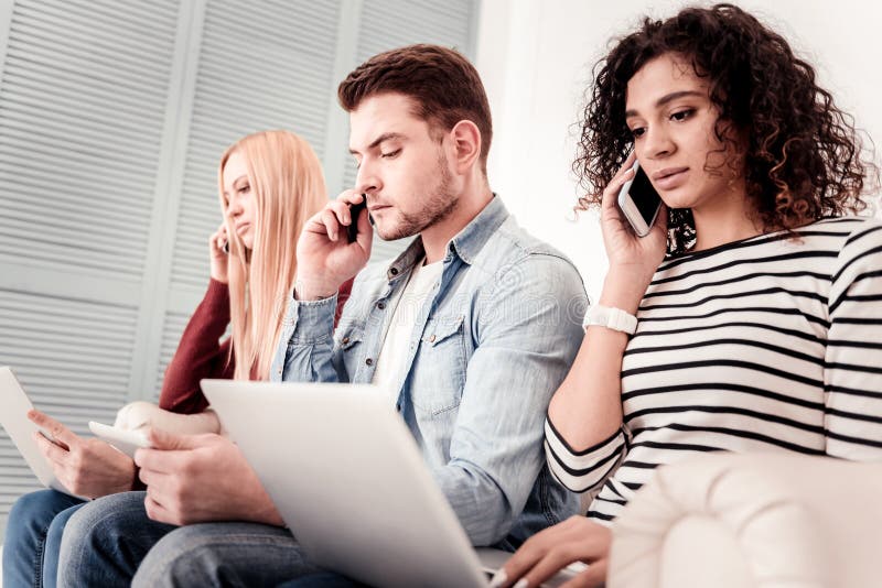 Serious Young People Making Calls Stock Image - Image of device ...
