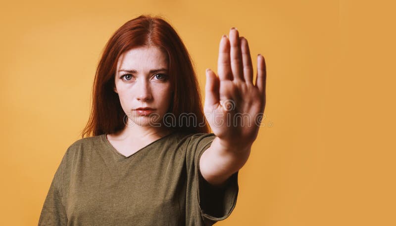 Serious Young Woman Making Stop Gesture with Left Hand Stock Photo ...