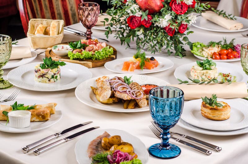 Served For Holiday Banquet Restaurant Table With Dishes Snack Salads Cutlery Wine And Water