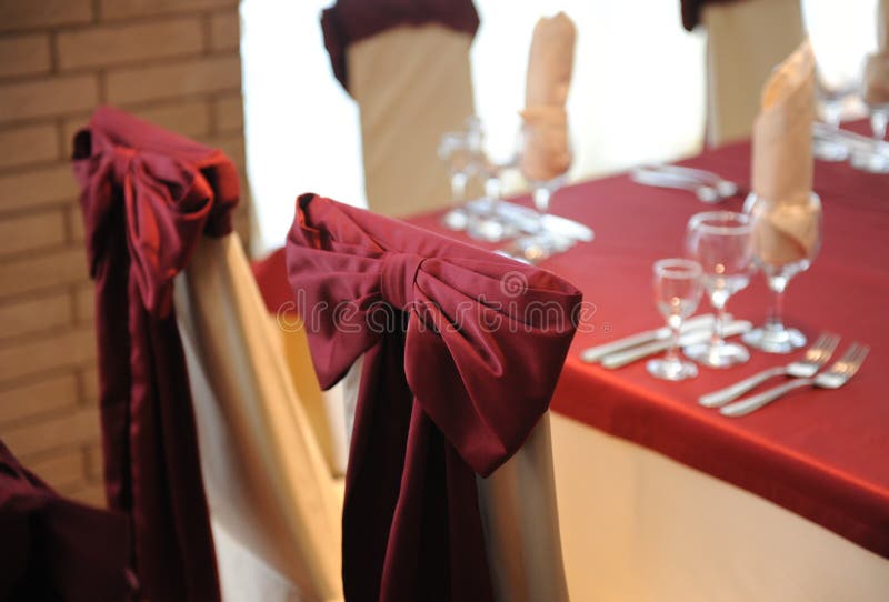 Served Table in a Restaurant. Cream and Maroon Colors. Bows Drapery on ...