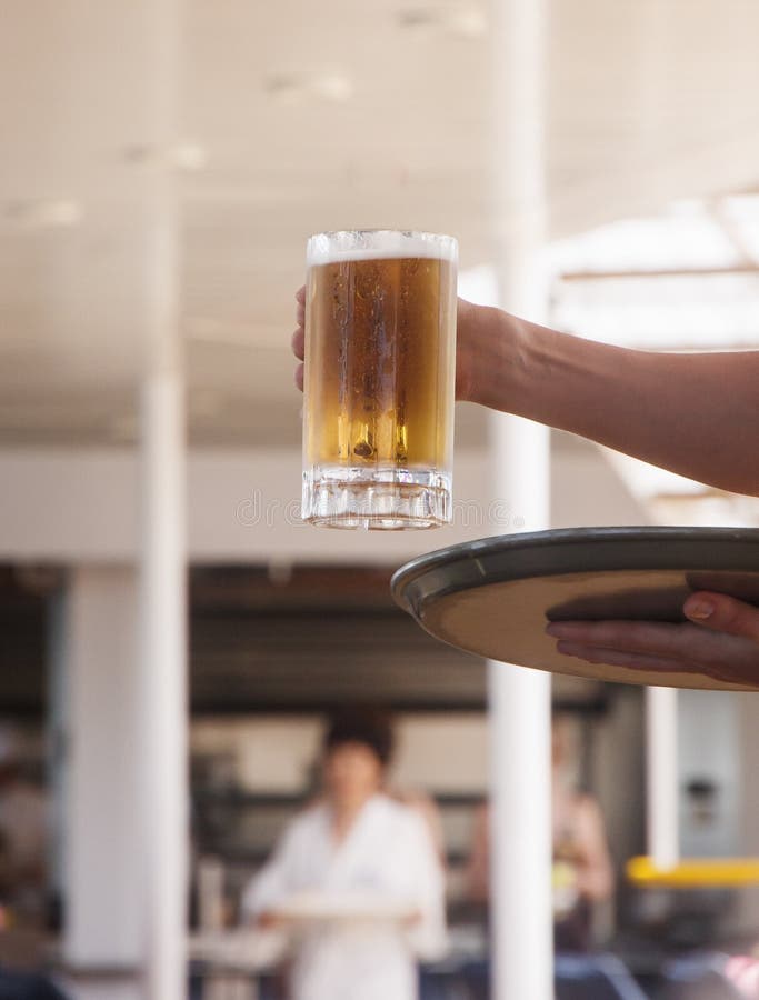 Server Carrying Mug of Beer Stock Image - Image of serving, cold: 26029625
