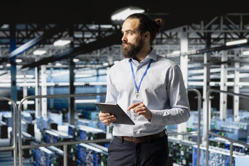 Server Hub Employee Doing Maintenance on Server Rigs with Tablet Stock ...