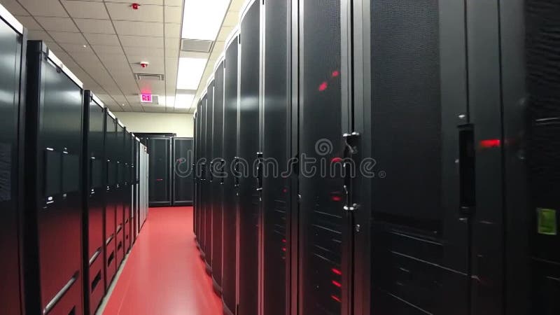 Server Racks in a Data Center, Organized in Rows on a Red Floor Beneath ...