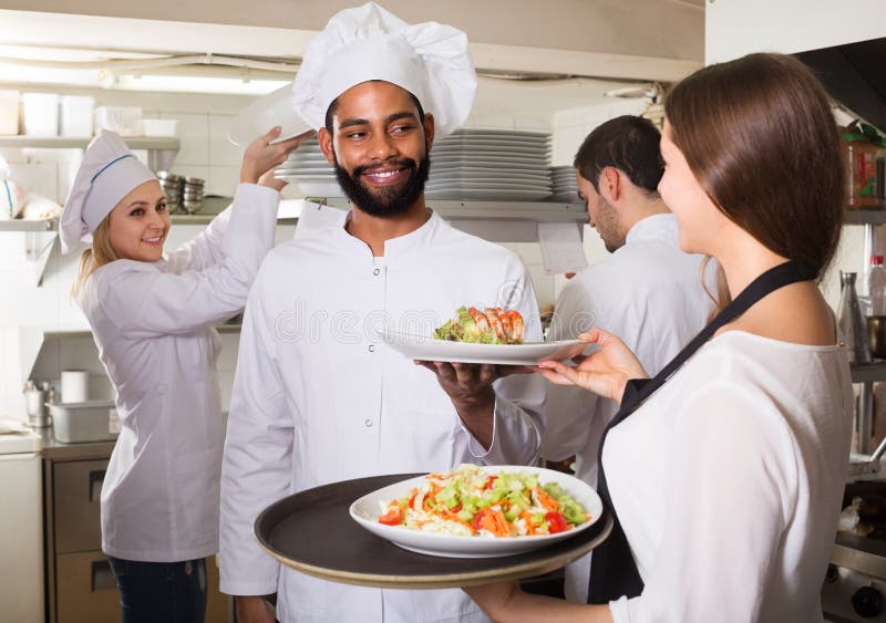 Serveuse Et équipe De Cuisson Dans Le Restaurant Image stock - Image du ...