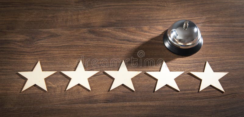Service Bell and Wooden 5 Stars on the Wooden Table Stock Photo - Image ...
