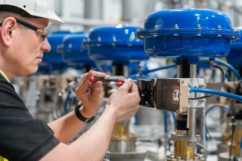 A Service Engineer Checks an Pneumatic Valve with a Screwdriver Stock ...