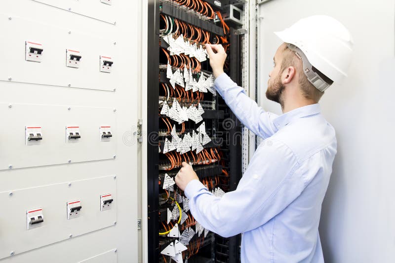 The Engineer In A Data Processing Center Stock Photo - Image of orange ...
