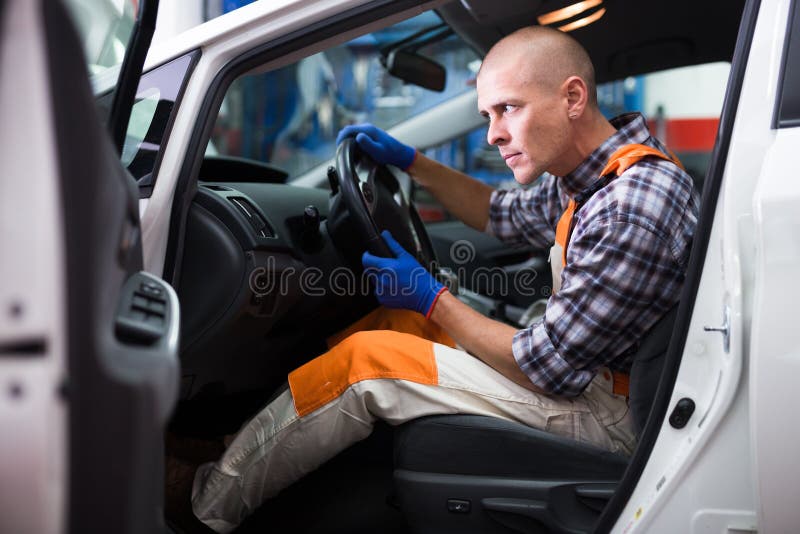 Service Engineer in Uniform Repairs a Car Steering Wheel Stock Image ...