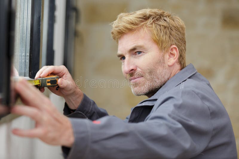 Service Man Installing Window with Measure Tape Stock Image - Image of ...