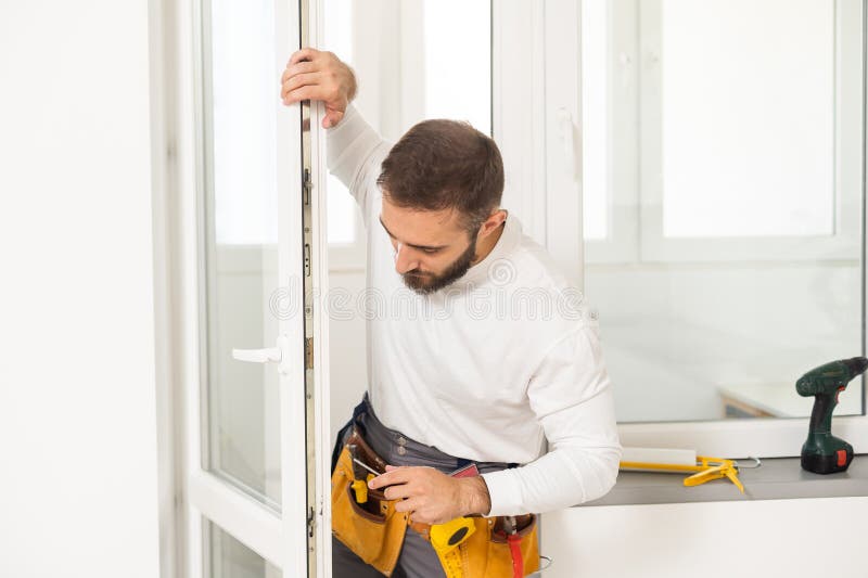 Service Man Installing Window with Screwdriver Stock Photo - Image of ...