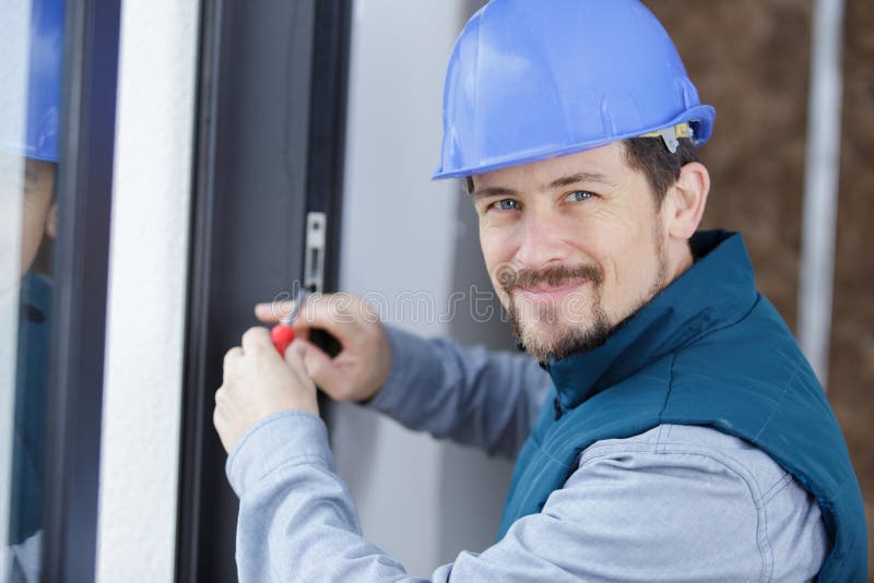 Service Man Installing Window with Screwdriver Stock Photo - Image of ...