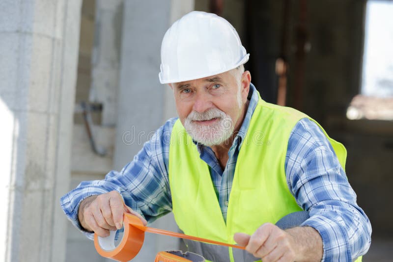 Service Man Using Masking Tape Stock Image - Image of room, mature ...