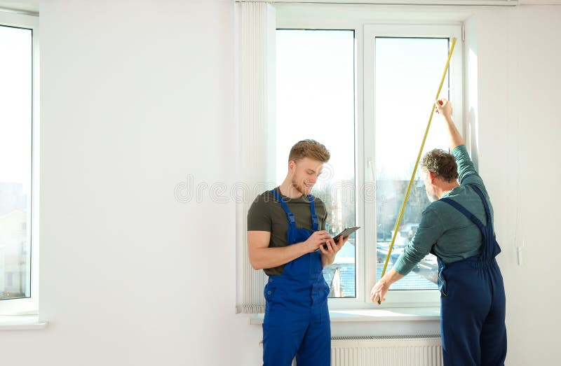 Service Men Measuring Window for Installation Indoors. Stock Photo ...