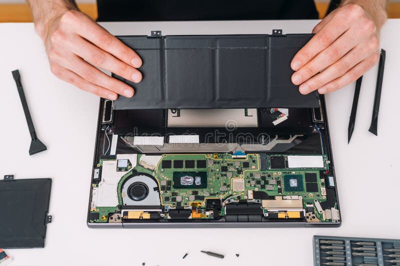 Service Technician Remove, Recycle and Replace Old Battery on Laptop ...