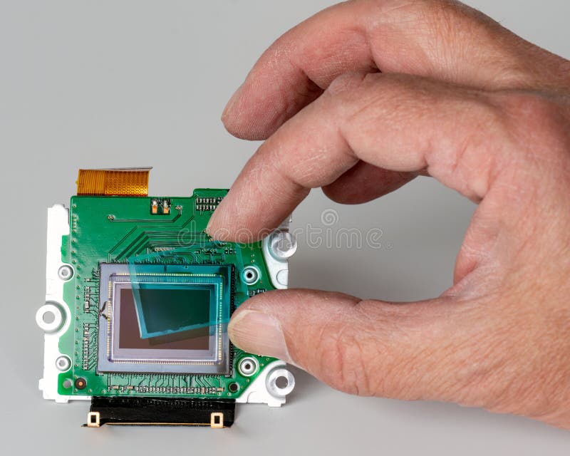 Service Worked Adds a Filter Over a Camera Imager Sensor Stock Photo ...